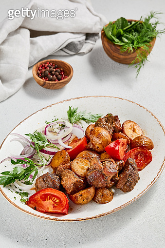 Traditional georgian dish odjahuri with meat and potatoes. Roasted pork ...