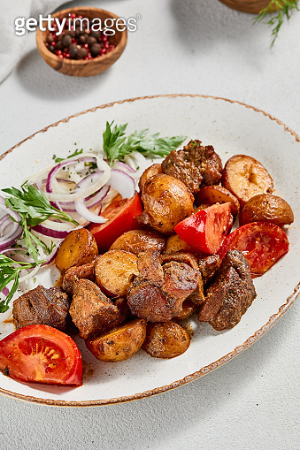 Traditional georgian dish odjahuri with meat and potatoes. Roasted pork ...