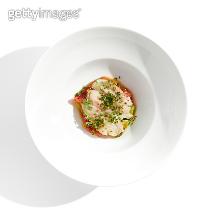 Healthy dinner - fish fillet with tomato and avocado on white plate ...