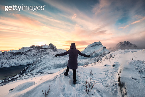 Climber woman standing on snowy peak and mountain range view in the ...