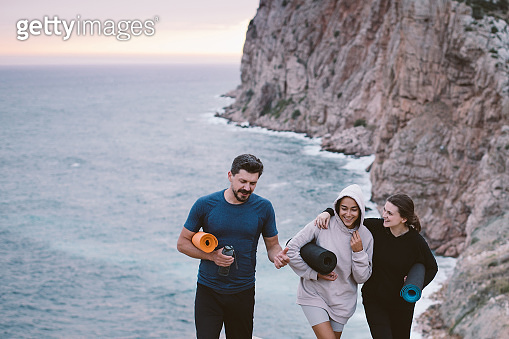 Group of young people going home from yoga class outdoors with ...