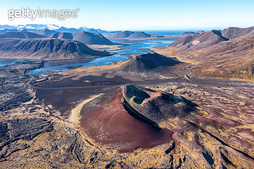 Extinct volcano, lava fields, lakes and mountains, with the sea in the ...