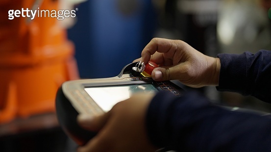 safety first hand push emergency button. Close up shot of mechanic ...
