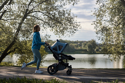 Active mother jogging. Jogging or power walking woman with a baby ...