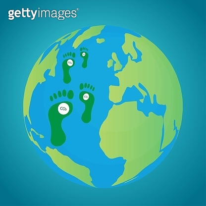 Row of green human footprints walking over the Earth globe, carbon ...