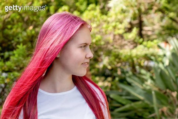 Cute teenage girl with bright raspberry pink ombre long colored hair ...