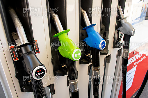Petrol and diesel pumps hoses on Ampol petrol station. Fuel nozzles oil ...