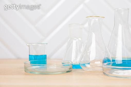 Laboratory glassware with test tubes. flasks, dropper, petri dishes ...