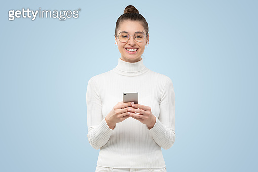 Studio shot of beautiful girl, looking straight at camera, smiling ...
