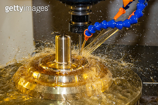 The CNC milling machine cutting the shell mold parts with oil coolant ...