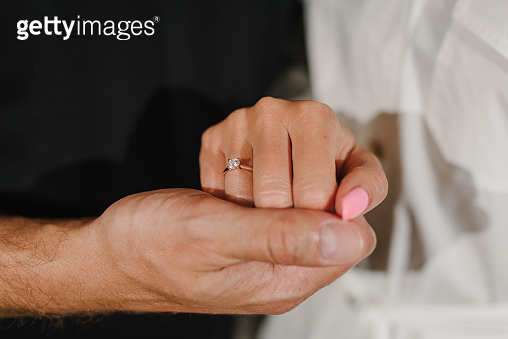 Man in love putting an engagement ring on woman finger. Propose ...