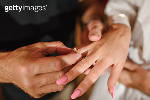 Man in love putting an engagement ring on woman finger. Propose ...