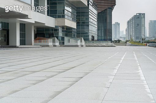 empty ground floor in front of modern office buildings in city downtown ...