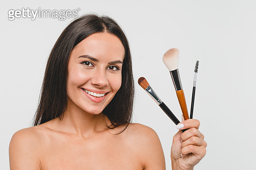 Attractive young woman girl lady using cosmetics brush to apply ...