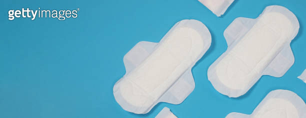 Woman sanitary napkins on blue background. Top view. Absorbent pads ...
