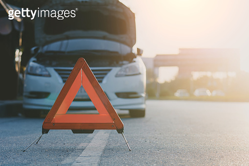 Red emergency sign on a rural road car broken down on highway road ...