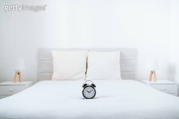 alarm clock at 10 am on bedroom during morning, wake up concept ...