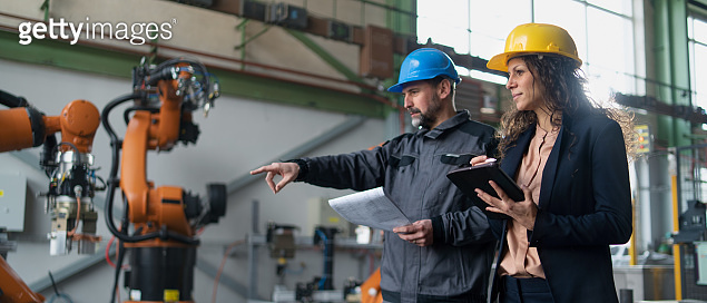 Female engineering manager and mechanic worker doing routine check up ...