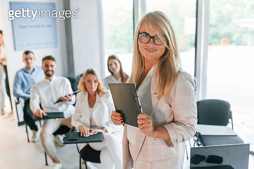 Senior woman is making master class. Group of professional business ...