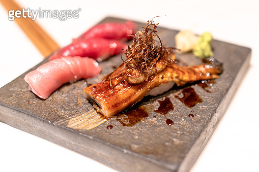 Selective focus. A plate of tuna sushi and unagi nigiri or eel sushi ...