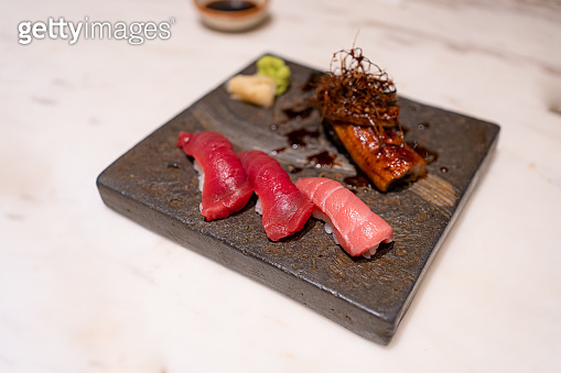 Selective focus. A plate of tuna sushi and unagi nigiri or eel sushi ...