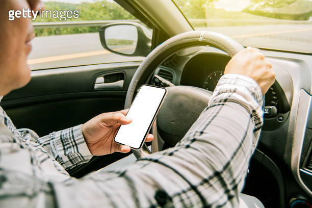 Man using his phone while driving, Person holding the cell phone and ...