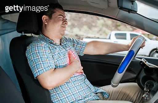 Suffering driver with chest pain. Male driver with chest pain in ...