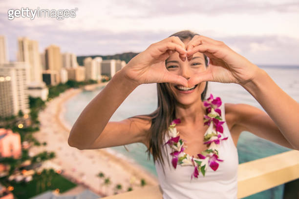 Happy Hawaii Waikiki beach tourist doing heart shape with hands ...