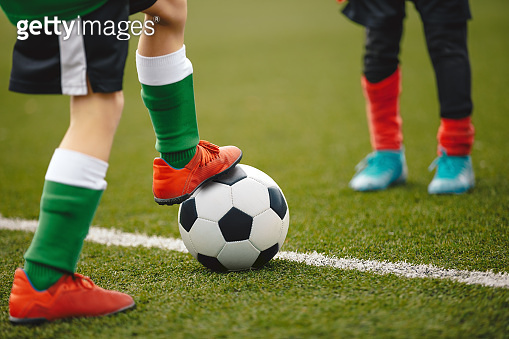 Legs of Soccer Player Kicking Classic Soccer Ball. School Kids ...