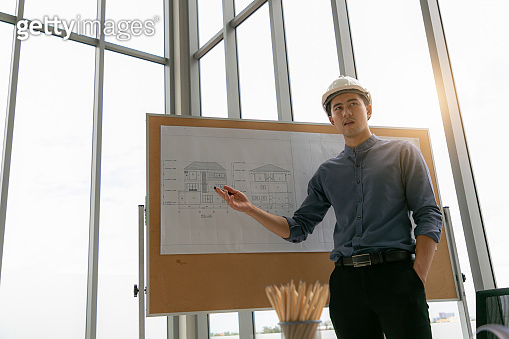 Asian man of middle aged industrial male engineer working and explain ...