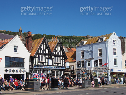 tourists walking past cafes and the newcastle packet pub on sandside in ...