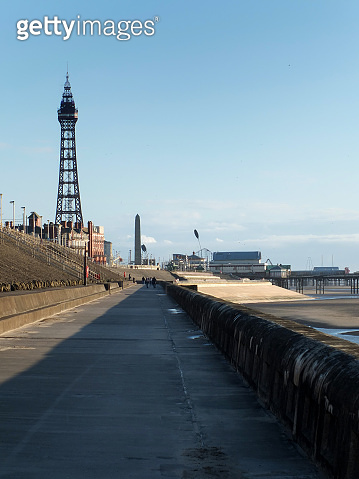 view of blackpool tower and south pier from the promenade with town ...