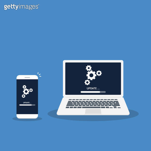 Laptop and smartphone with update process screen. Install new software ...