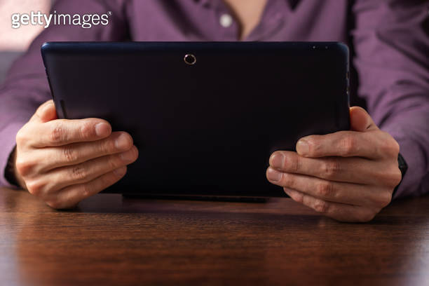close up hands multitasking man using tablet, laptop and cellphone ...