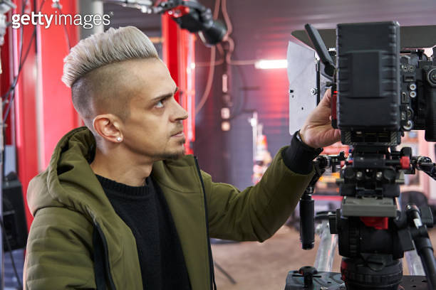 handsome caucasian man with mohawk haircut operating a professional ...