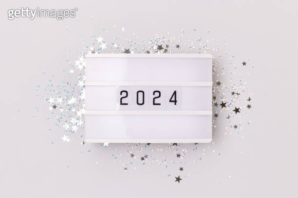 Lightbox with 2024 numbers and glowing silver stars confetti ...