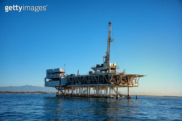 Off-shore fracking drill rig in morning on the pacific ocean near long ...