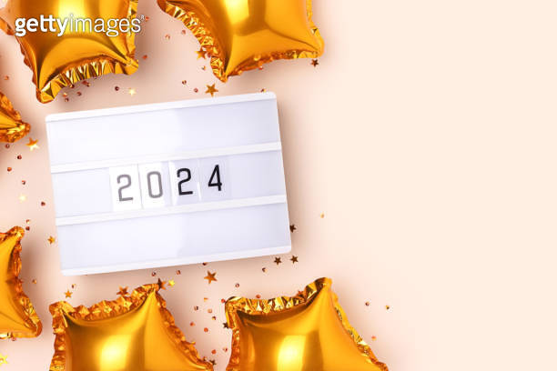 Lightbox with 2024 numbers. Gold colored stars confetti and air ...