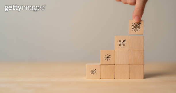 Challenge and growth concept. Small target goal to reach bigger target ...