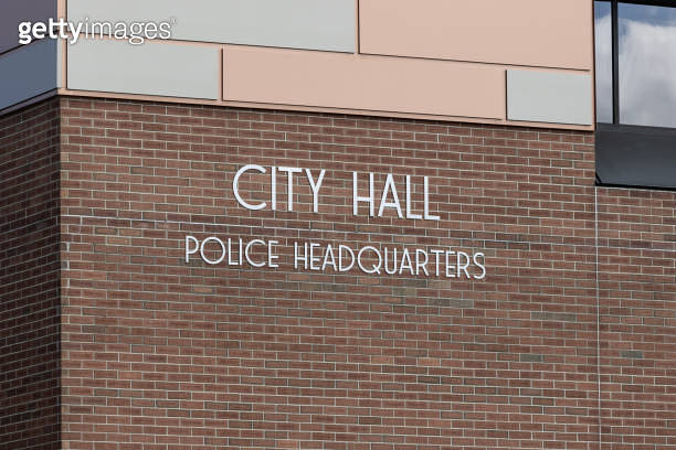 City Hall and Police Headquarters in bold stainless steel text on brick ...