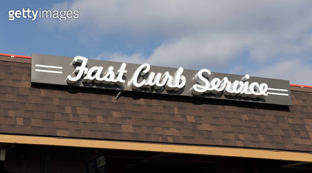 Fast Curb Service sign at a drive in restaurant. After COVID 19 ...
