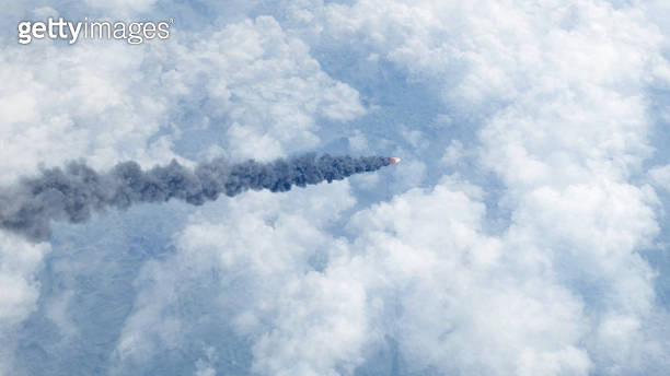 Meteor asteroid or rocket burning over clouds Aerial view over burning ...