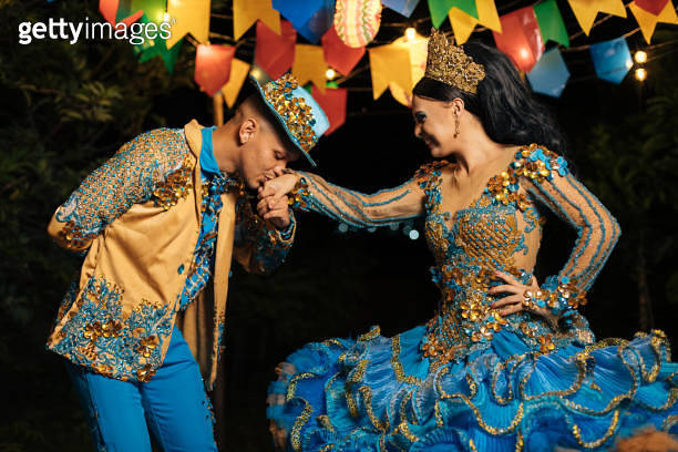 A professional Quadrilha dance couple, adorned in vibrant costumes ...