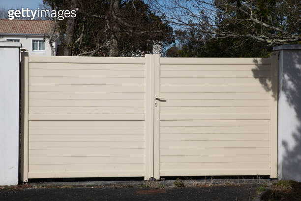 steel classic beige sand metal gate fence of white facade house street ...