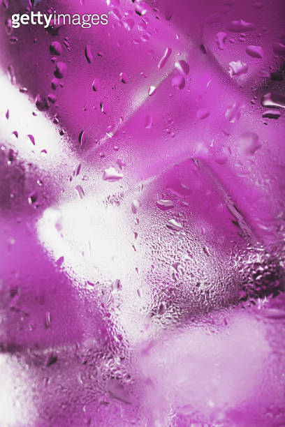 Ice cubes in a misted glass with drops of ice water close-up macro. Soft Selective Focus ...
