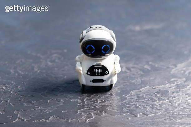 Real white small Robot on black table. Futuristic future technology ...