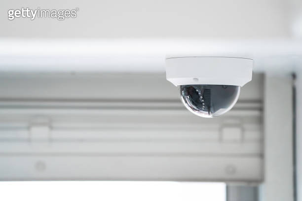 CCTV camera is installed inside the building on the ceiling and wall ...