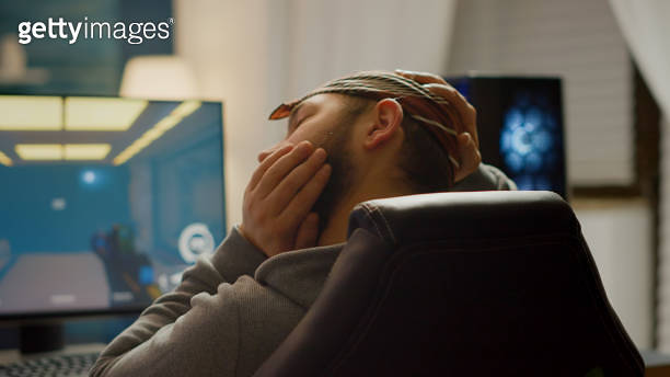 Back view shot of professional gamer playing in first-person shooter ...