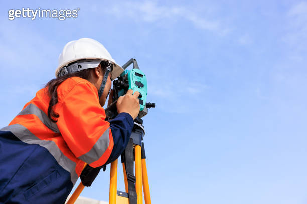 engineer use theodolite equipment for route surveying to build a bridge ...