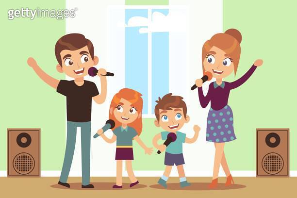 Karaoke time, parents and children sing songs into microphone. Mother ...